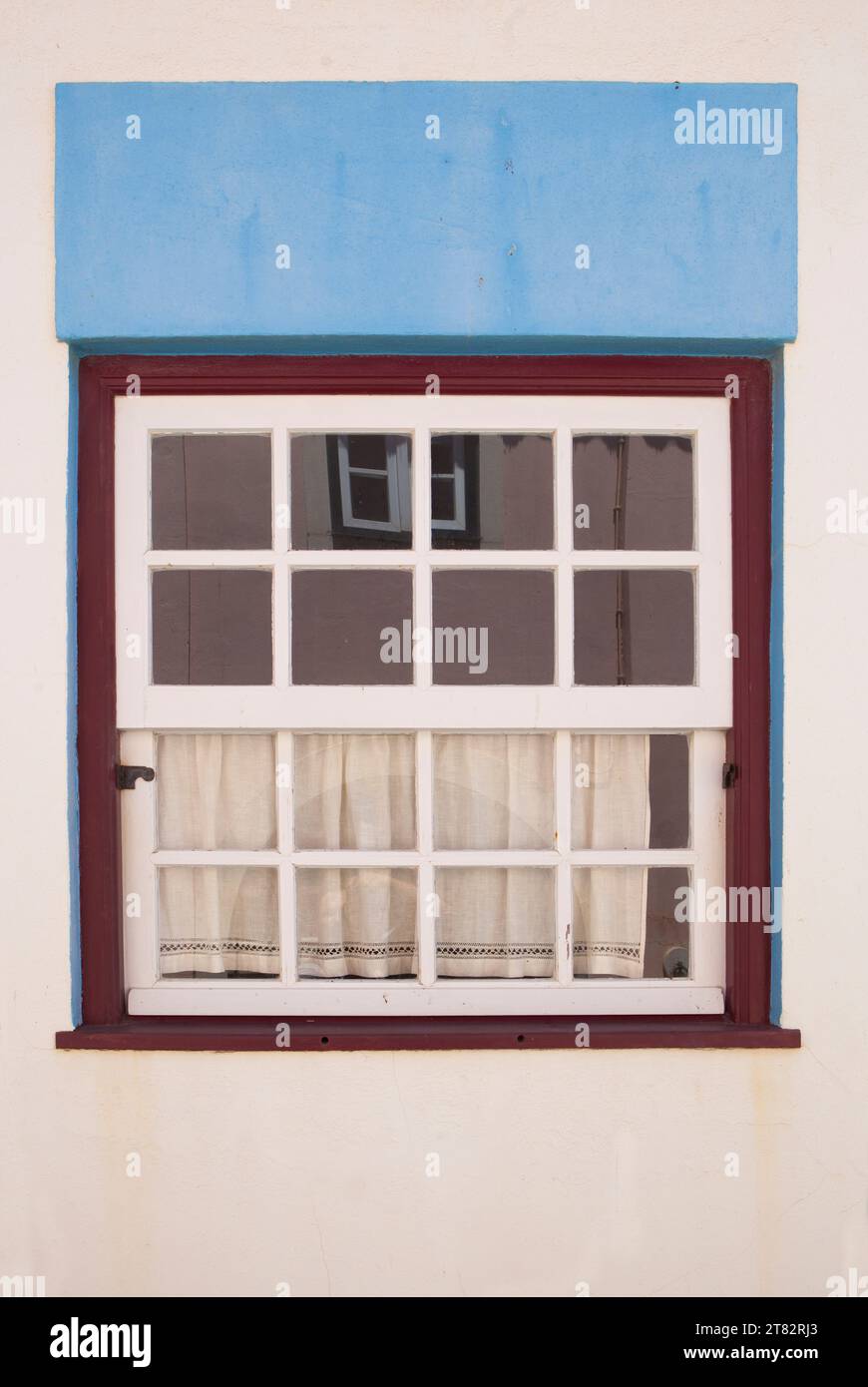 Tiny window painted with vivid colors at Vila Nova de Milfontes house ...