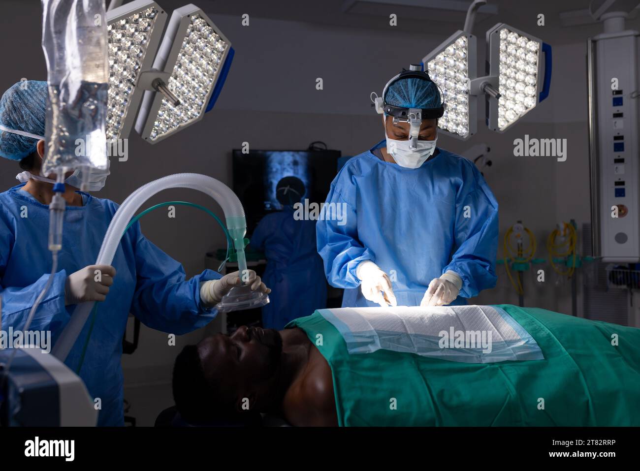 Diverse female doctors with face masks doing surgery in hospital ...