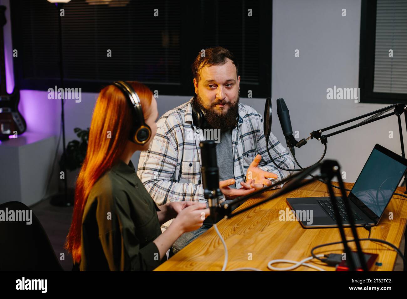 Radio presenters communicate during the broadcast of the evening show ...