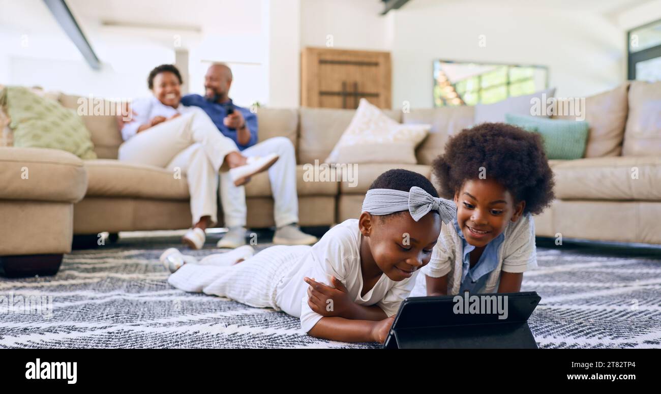 Family, children and tablet on floor watching cartoons, parents and ...