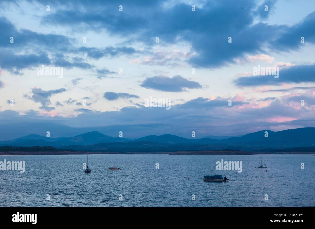 Leisure boats anchored on the shore of the Gabriel y Galan reservoir ...