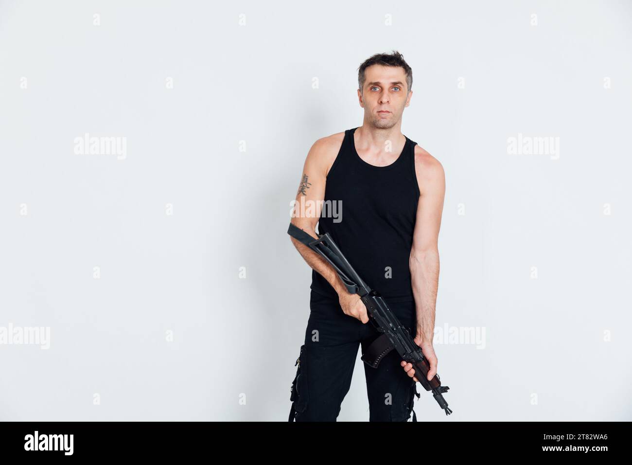 a man with a machine gun on a white background war Stock Photo - Alamy