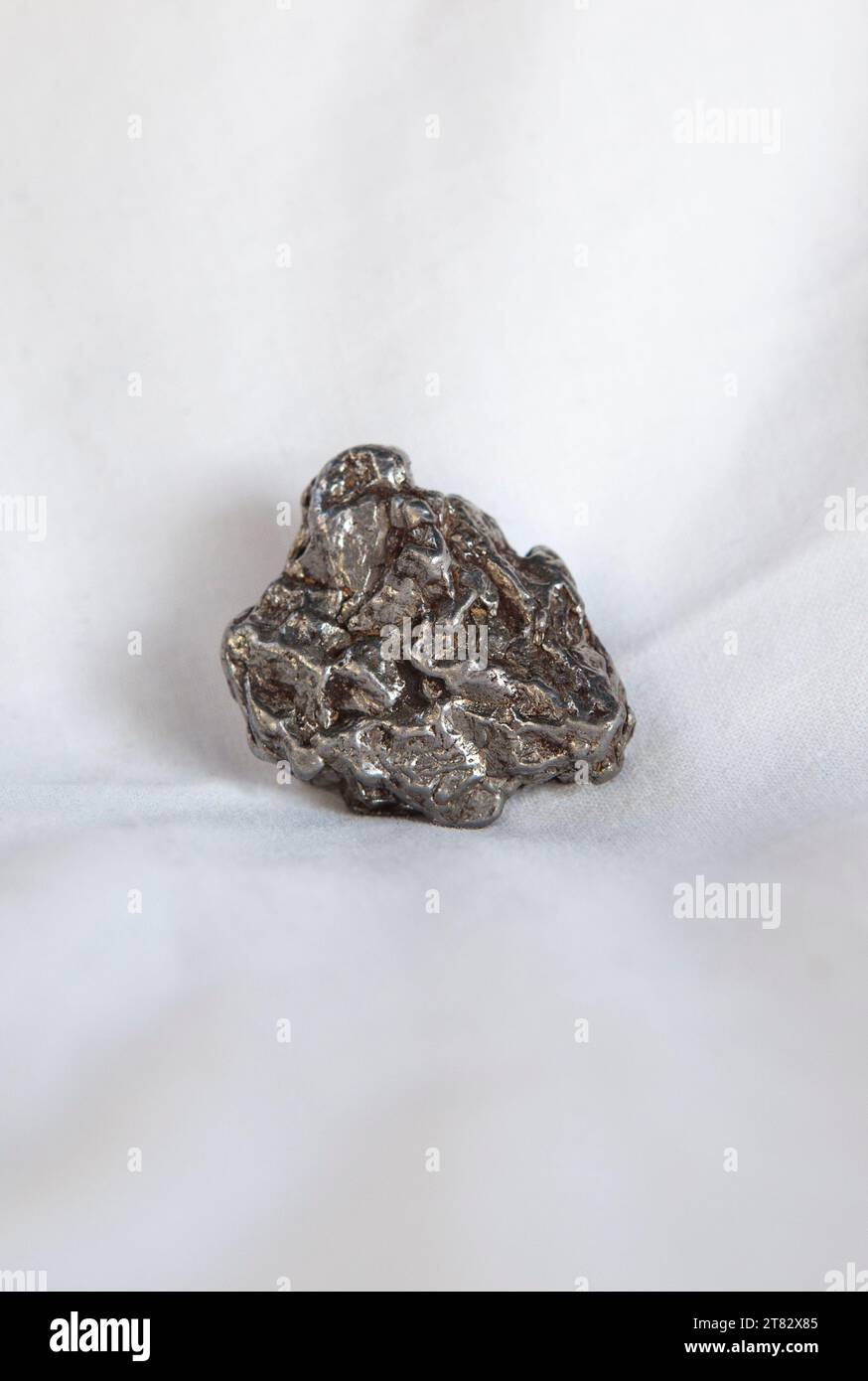 Nickel-iron type meteorite fragment. Placed over cotton cloth Stock ...