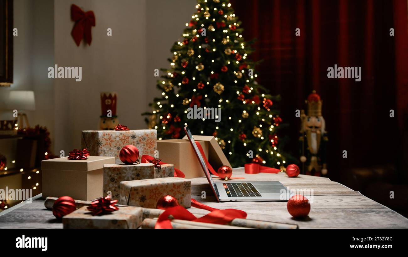 Desk with pc and presents under the Christmas tree Stock Photo - Alamy