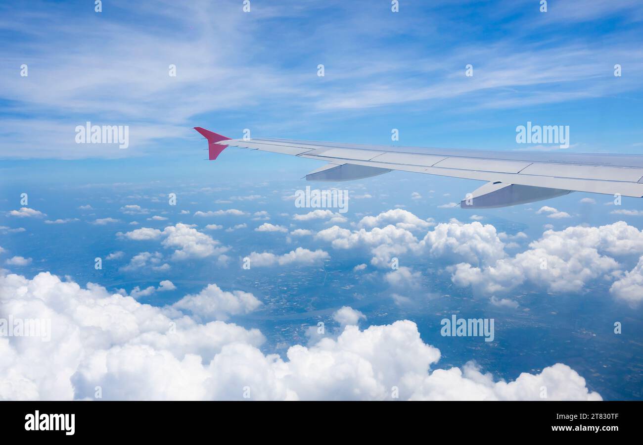 Aerial shot above the clouds. view of the sky and blue ocean from airplane Stock Photo - Alamy