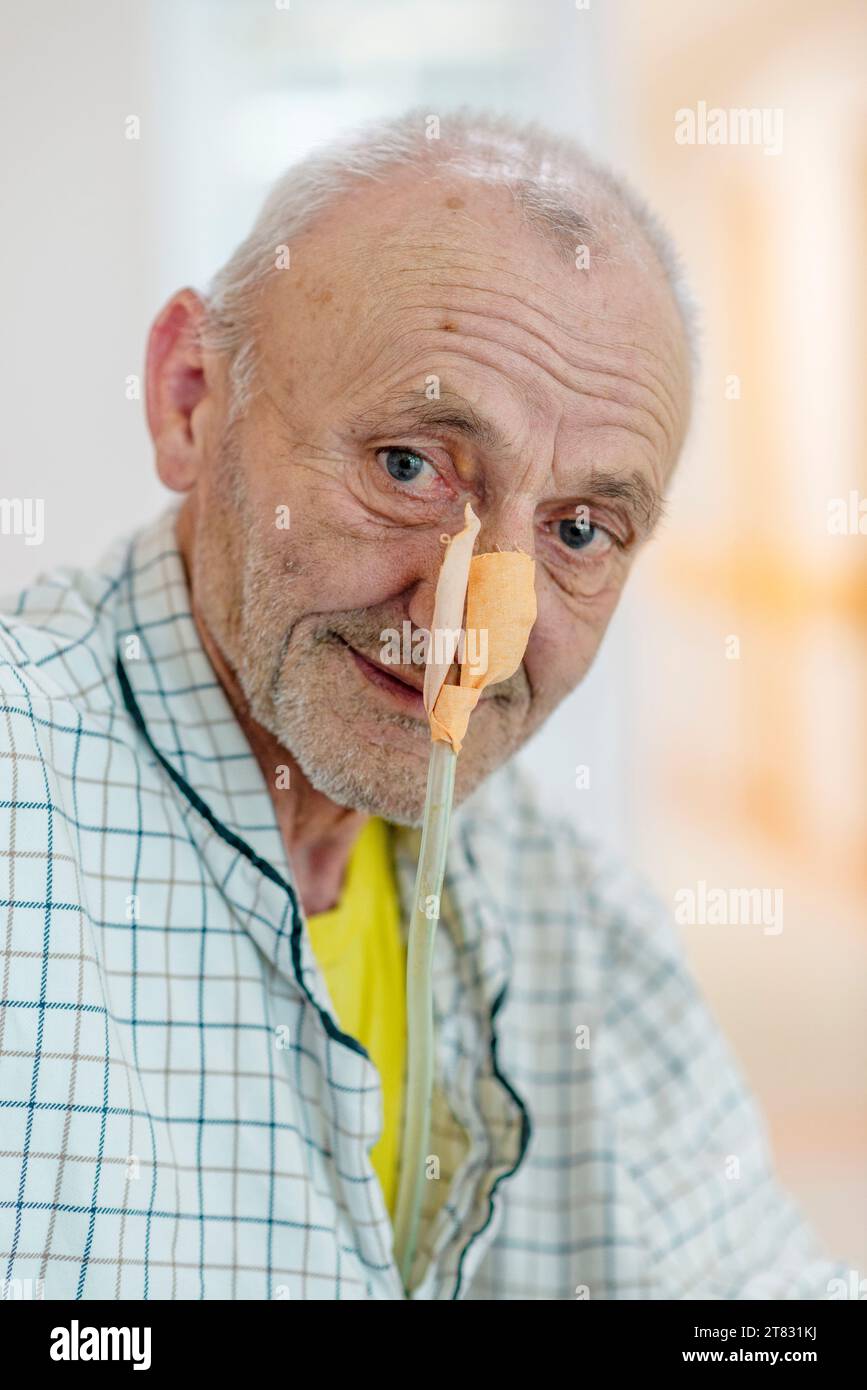 Patient with nasogastric tube on hospital bed waiting for treatment ...