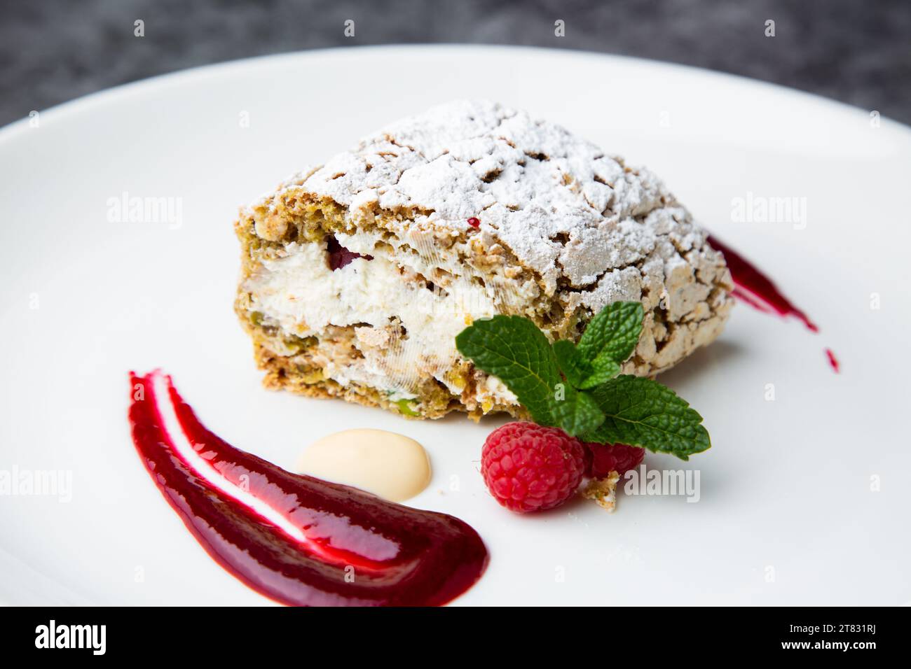 sweet sponge dessert with raspberries and powdered sugar side view ...