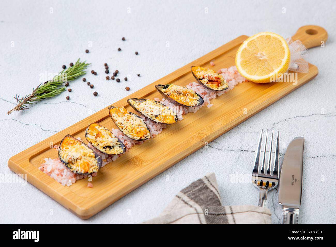 baked mussels with parmesan and lemon side view Stock Photo - Alamy