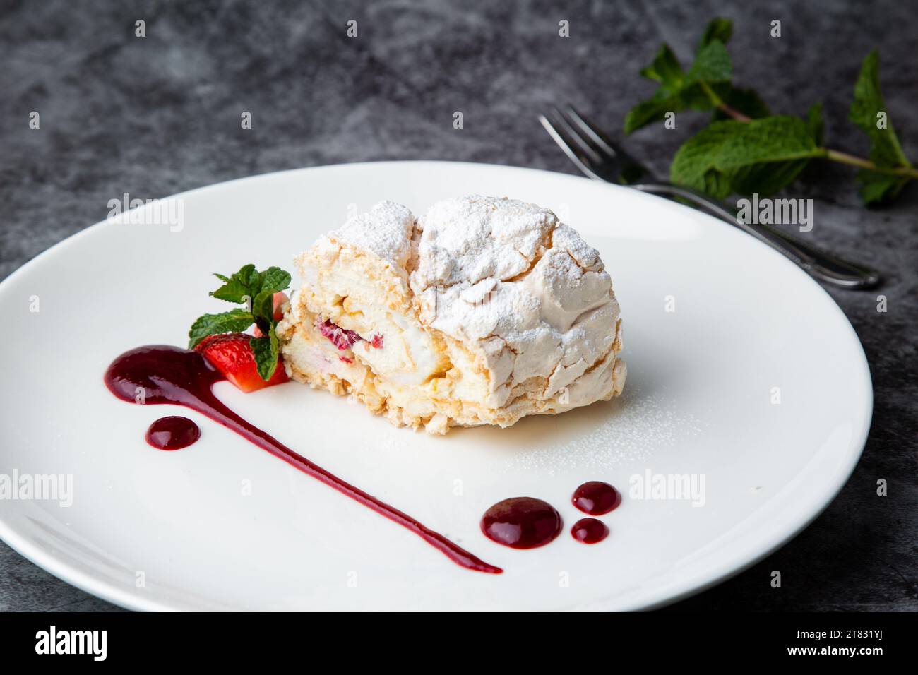 sweet sponge dessert with raspberries and powdered sugar side view ...