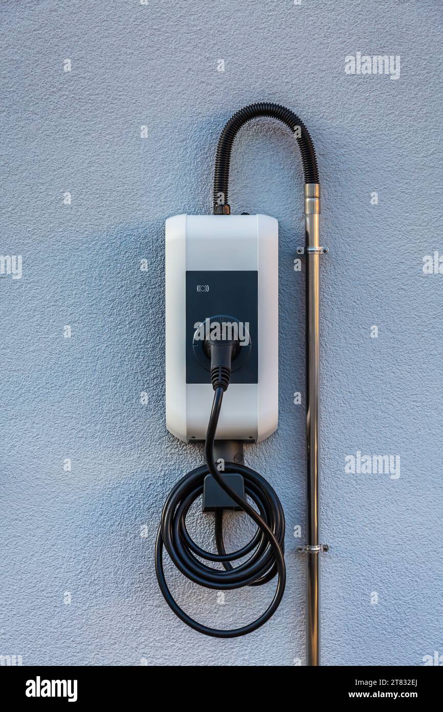 Wallbox on a family house wall for comfortable charging of electric car ...