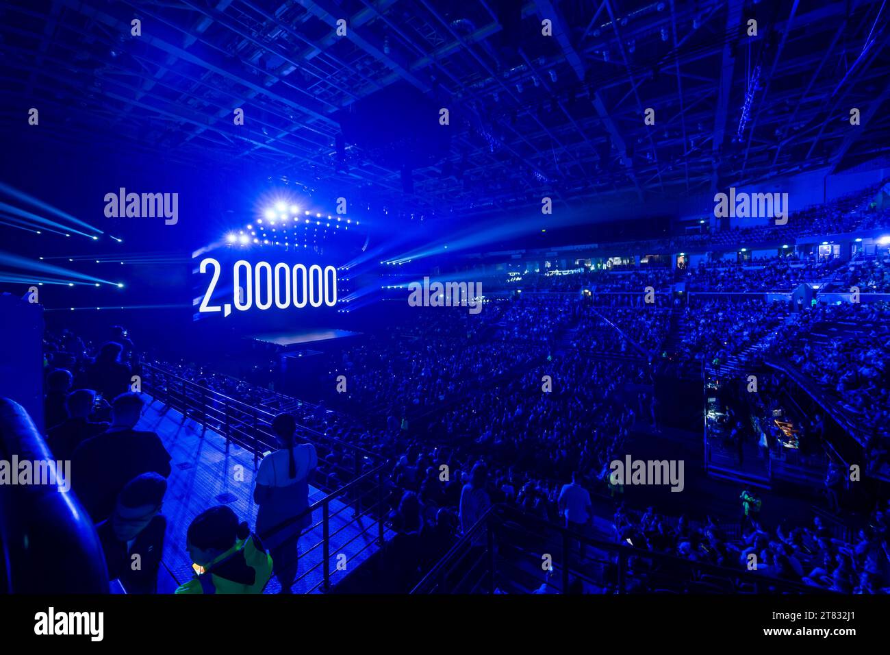 Aerial view of business crowd enjoying concert in large illuminated ...