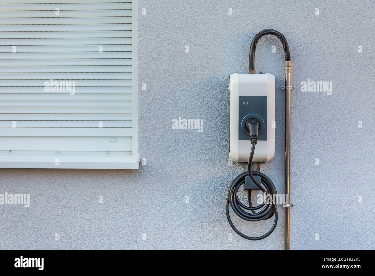 Wallbox on a family house wall for comfortable charging of electric car ...