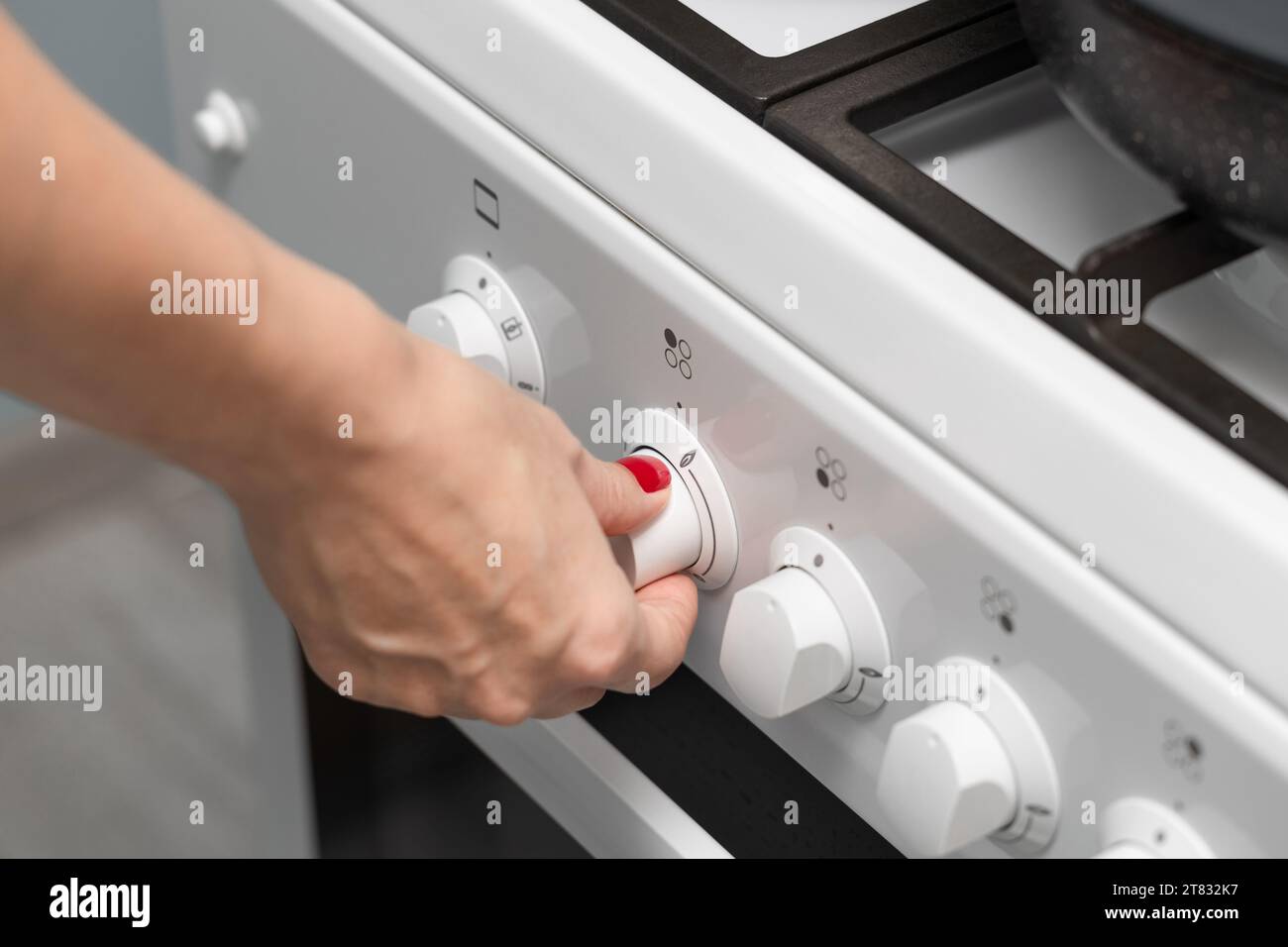a woman's hand rotates the selector on a gas stove. woman's hand turns ...