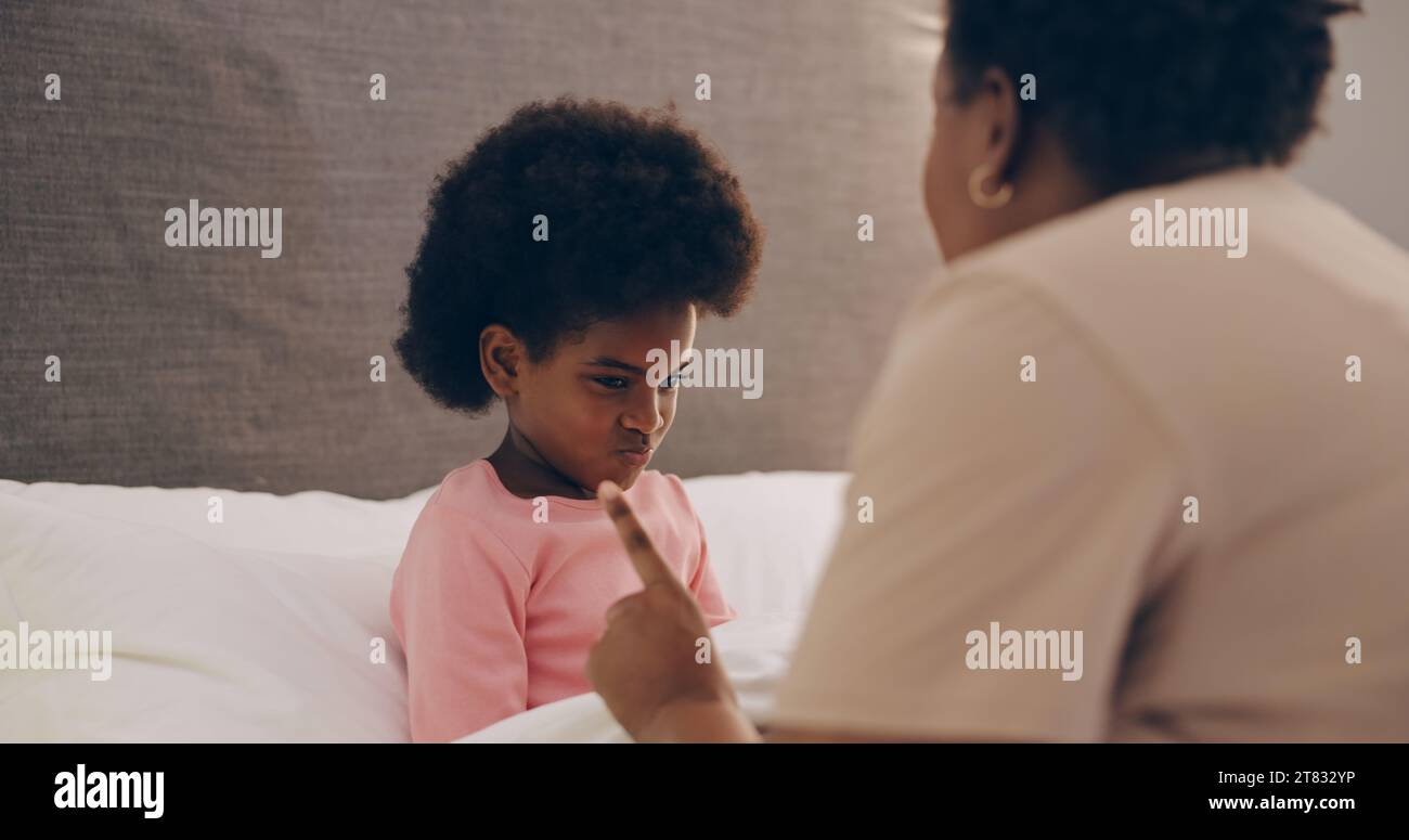 Mother, discipline and girl child in bedroom with strict parent talking ...