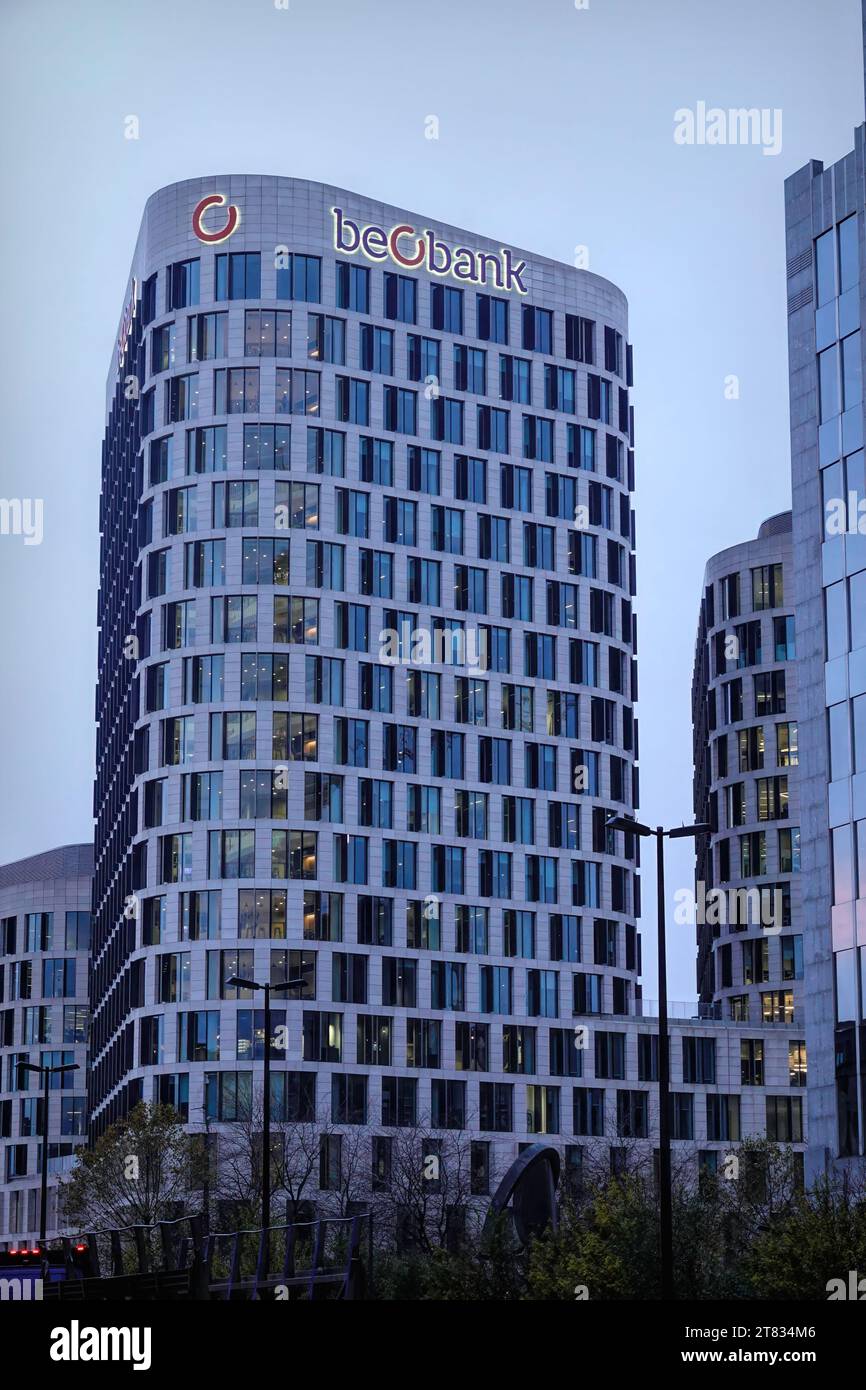 Vertical wide angle closeup on the tall sky-scraper headquarter offices of the modern curved ...