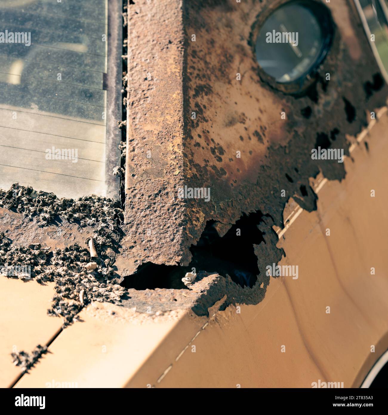 An old car with its window covered using dirt, creating a unique and ...