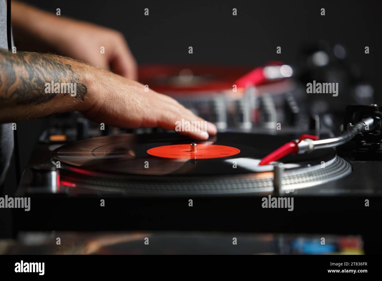 Club DJ scratching a record on a hip hop party. Professional disc ...