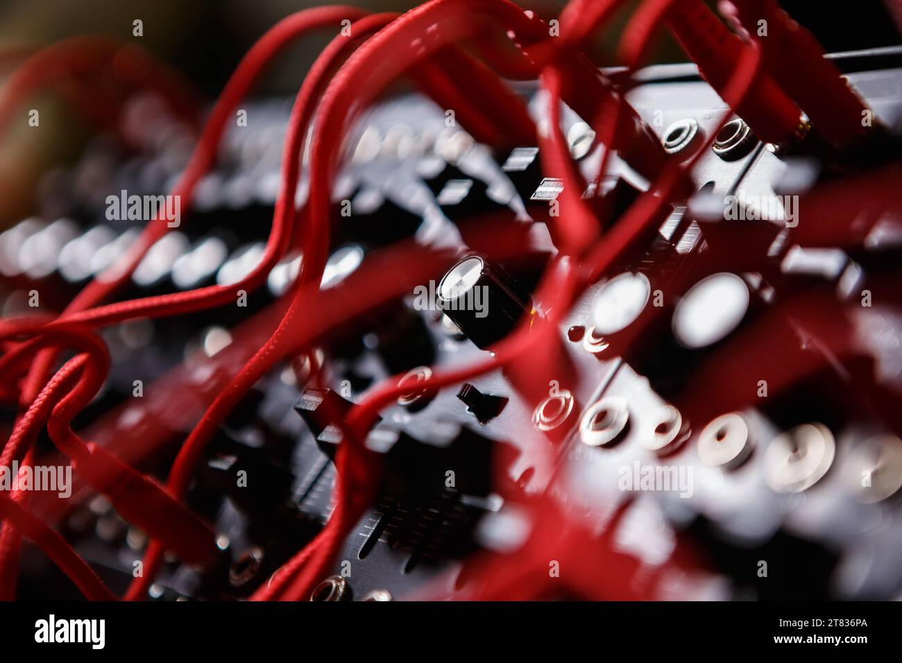 Analog modular synthesizer board connected with wires in sound recording studio. Professional ...