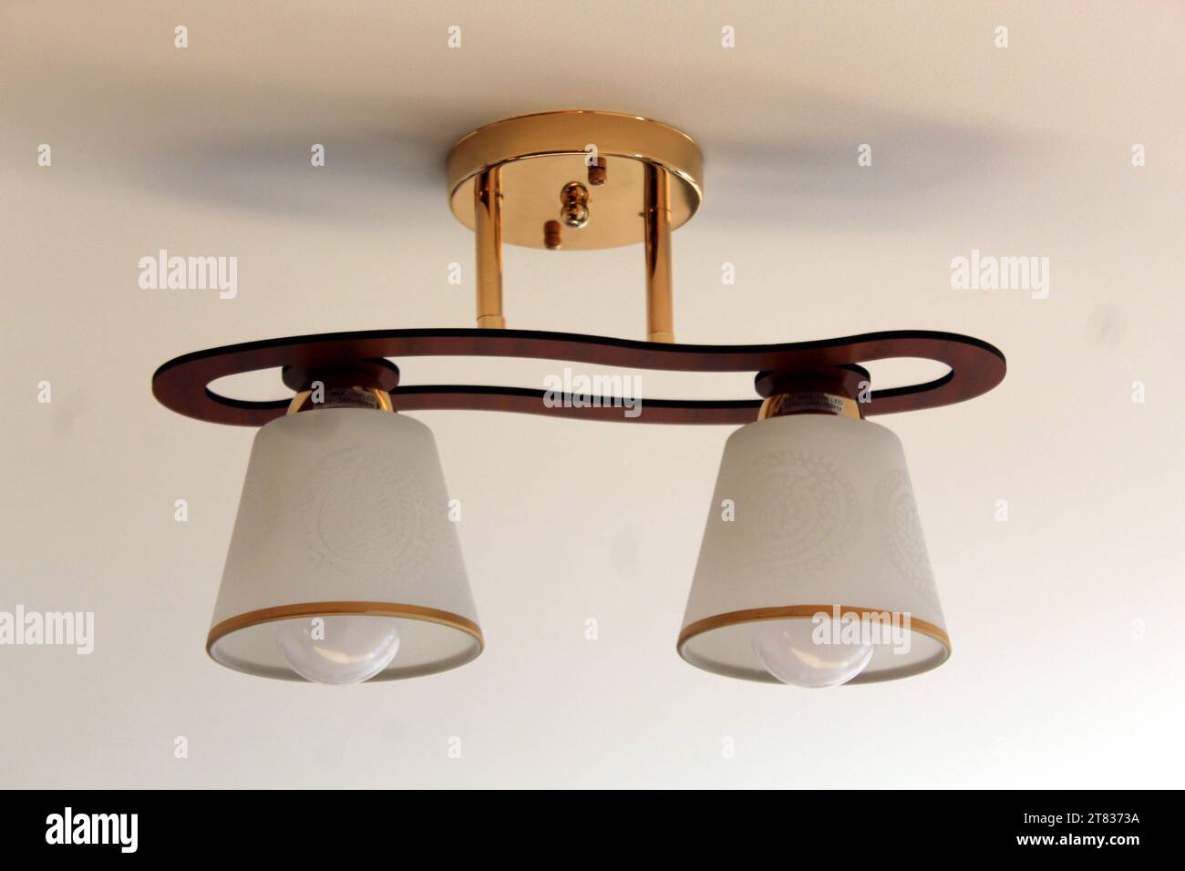 Chandelier with two white glass plafonds and brown base isolated on ...