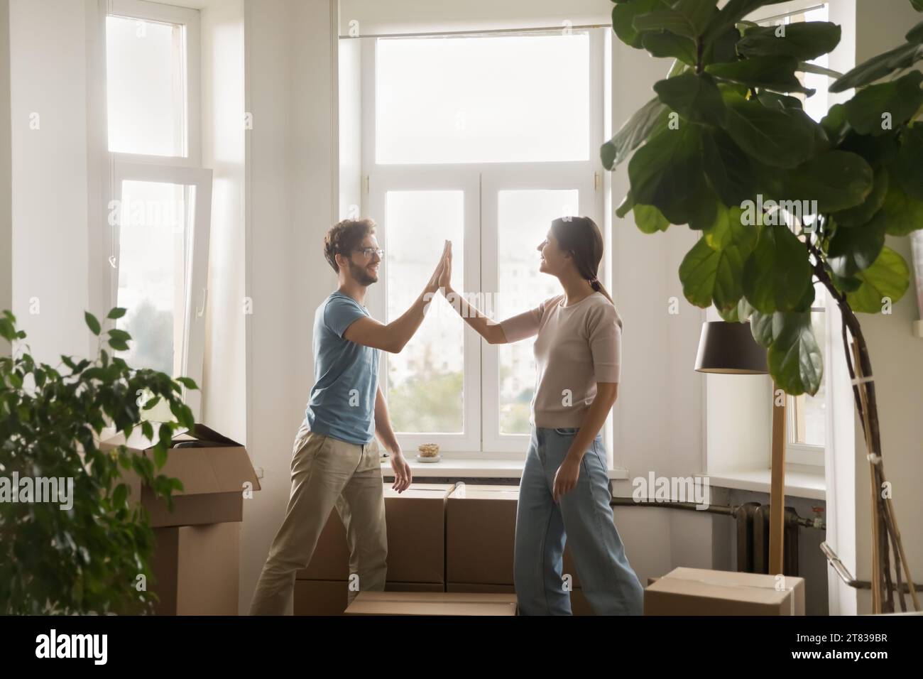 Couple giving high five congratulate each other with relocation day ...
