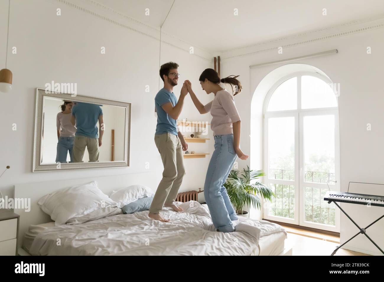 Couple jumping in bed hi-res stock photography and images - Alamy