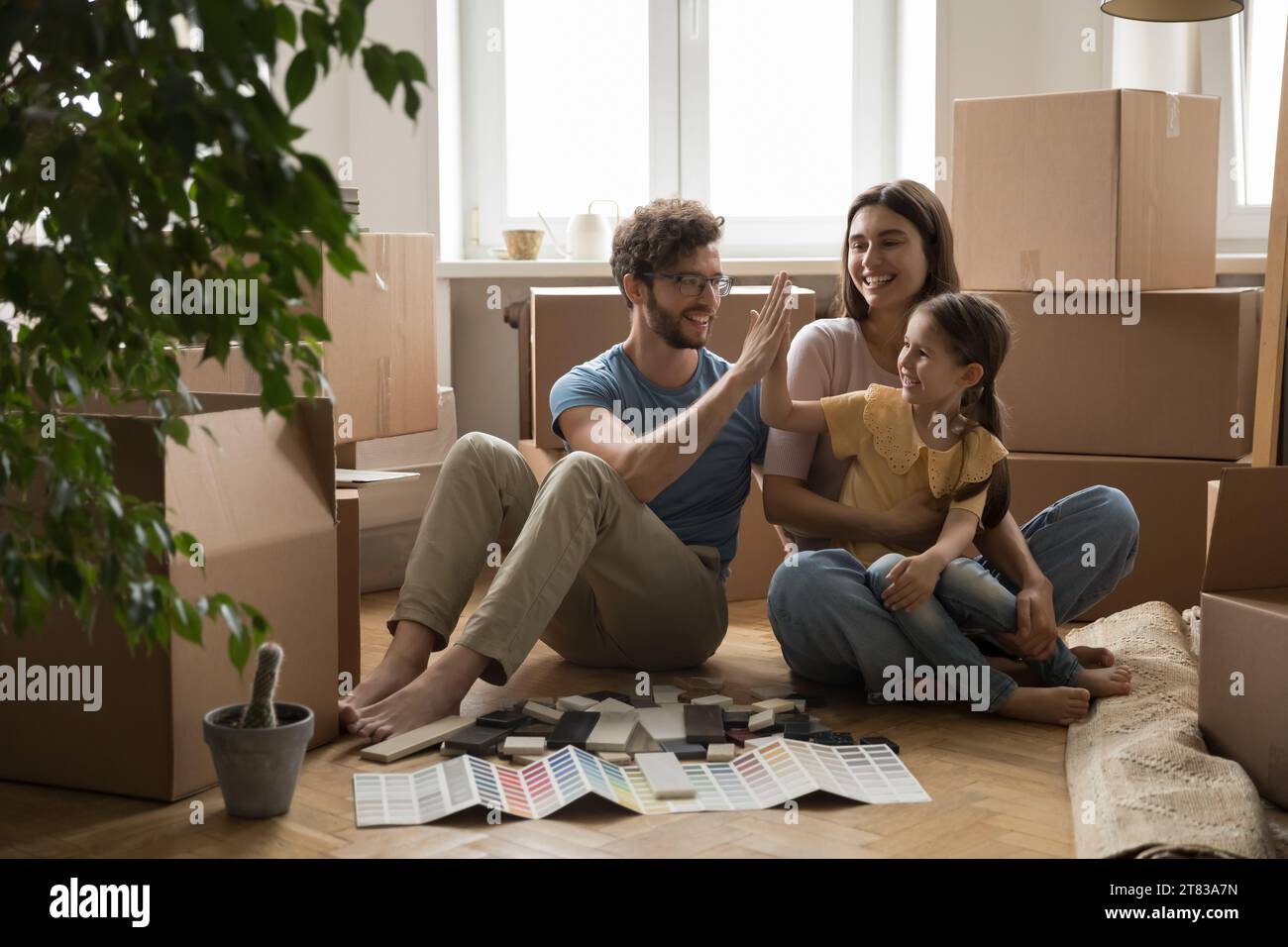 Family on relocation giving high five, start new house repairs Stock ...