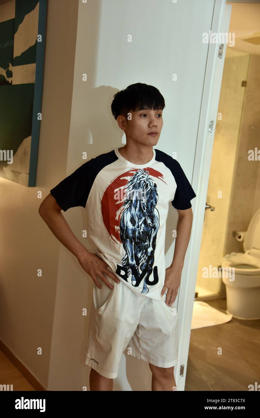 A handsome young, well dressed teenage, Asian boy or man, aged 18 to 24 ...