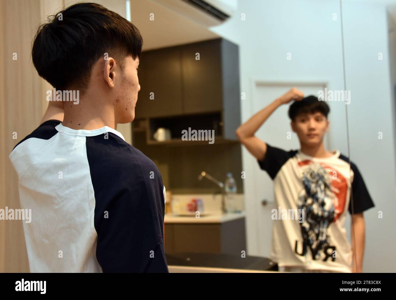 A handsome young, well dressed teenage, Asian boy or man, aged 18 to 24 ...