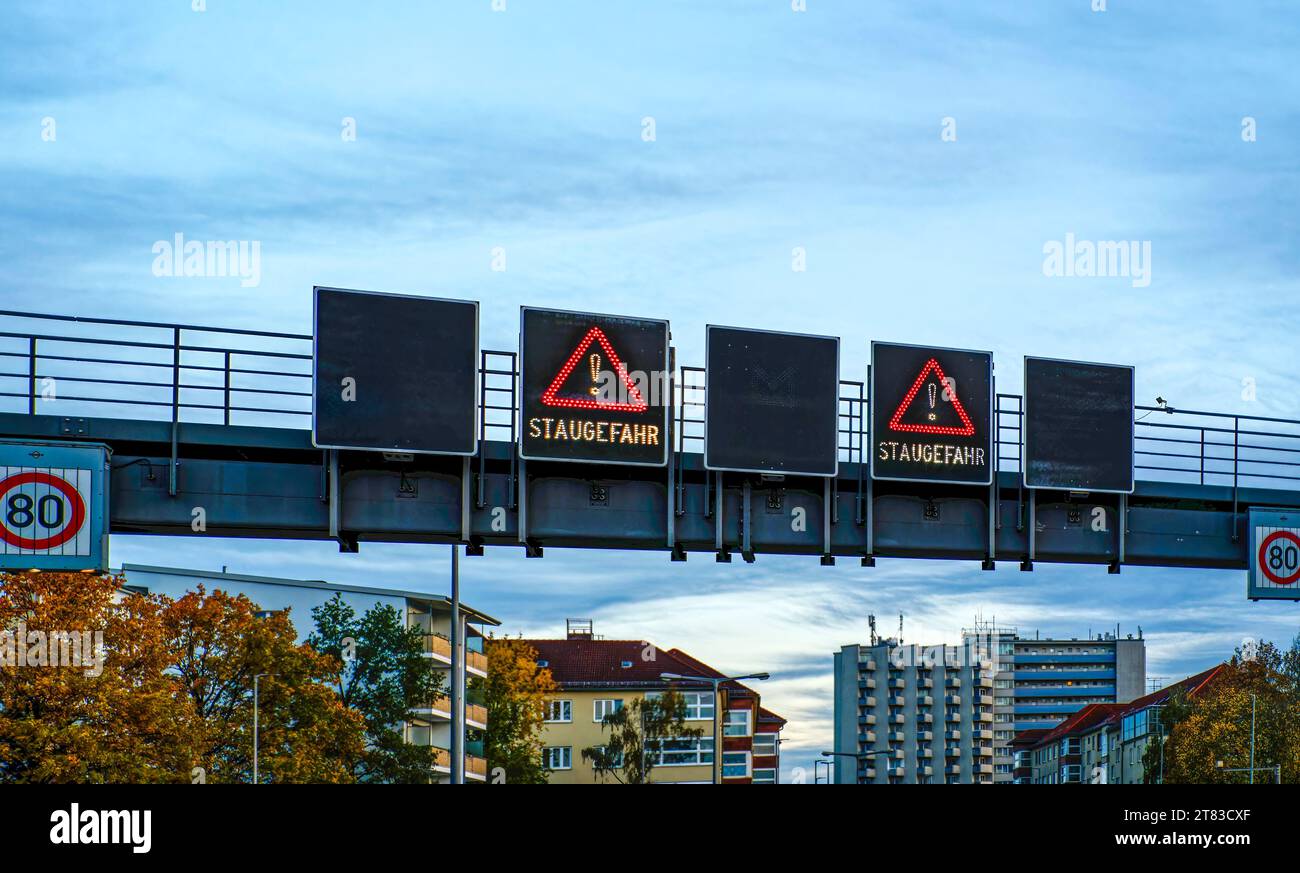 Automated sign bridge over a Berlin motorway with temporary traffic jam ...