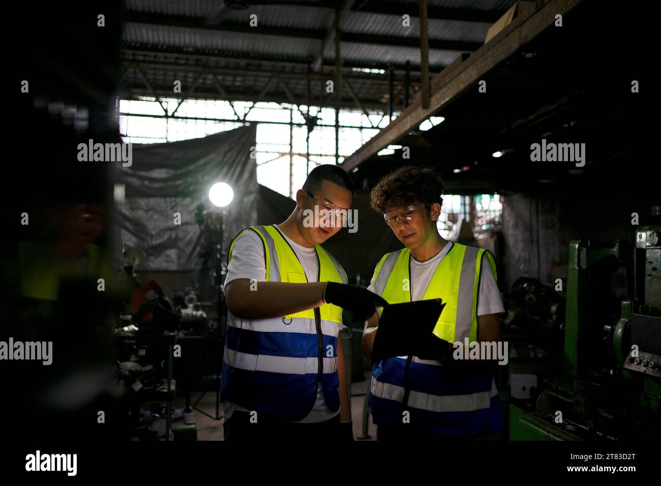 Trainee works at machine shop. Metalwork and education concept Stock ...