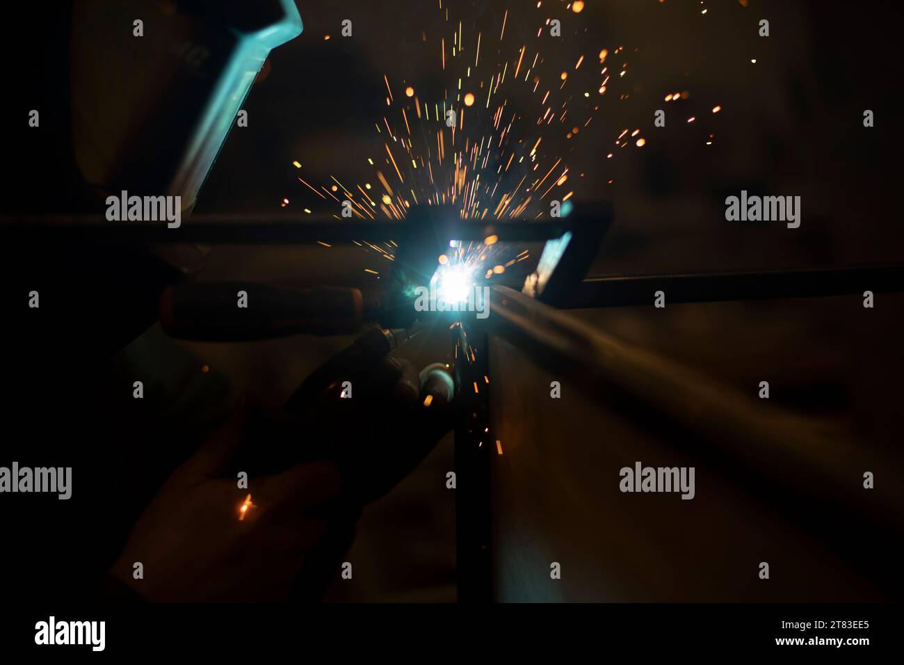 Welding work on metal. Blue fire from high temperature. Creation of ...