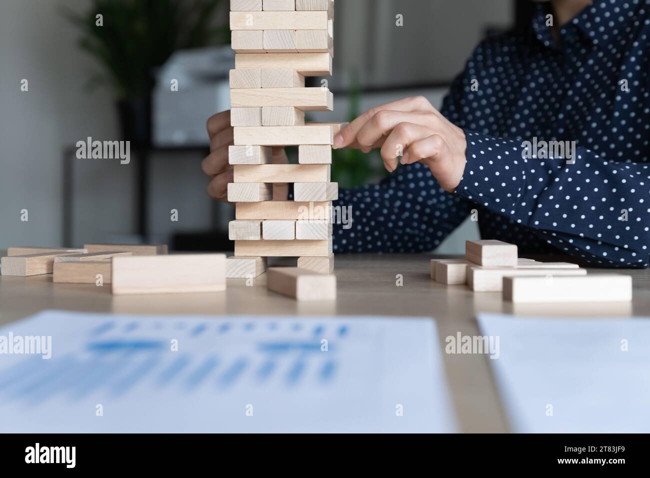 Hand of business woman, leader building stacked jenga tower Stock Photo ...