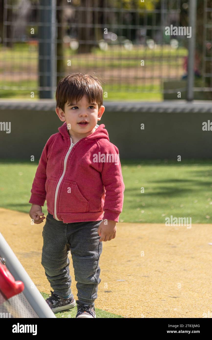 Child standing alone in playground hi-res stock photography and images ...