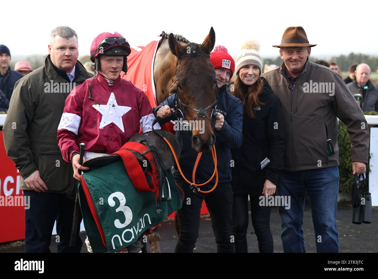 Jockey Sam Ewing, with trainer Gordon Elliott and winning connections ...