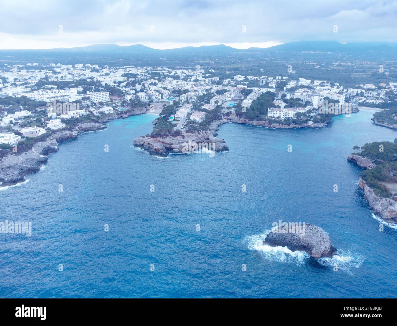 Aerial view of Cala Esmeralda , above the sea looking back at Menorca ...