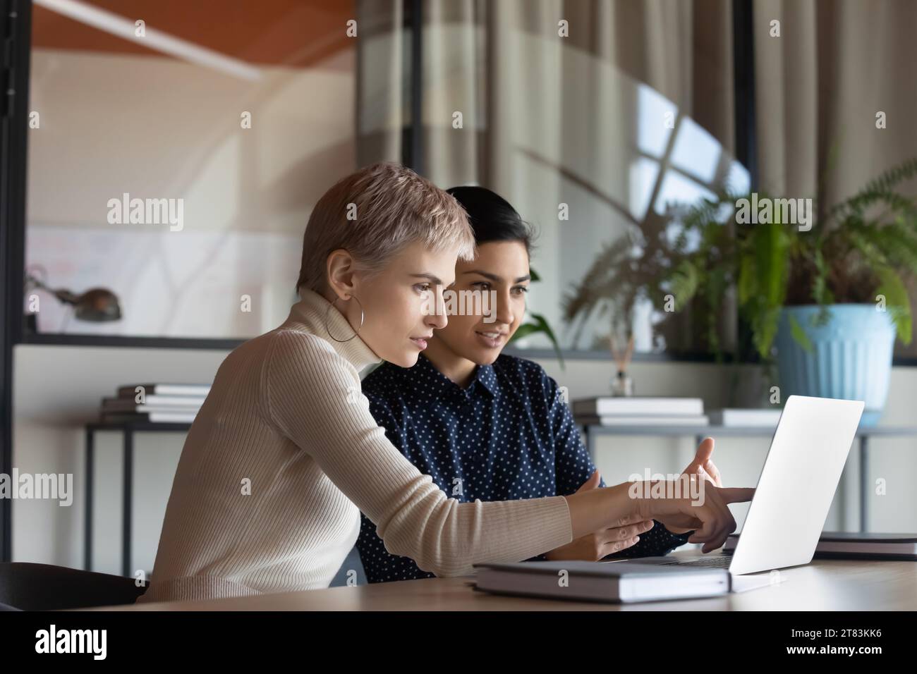 Corporate teacher showing new employee learning video at laptop Stock ...