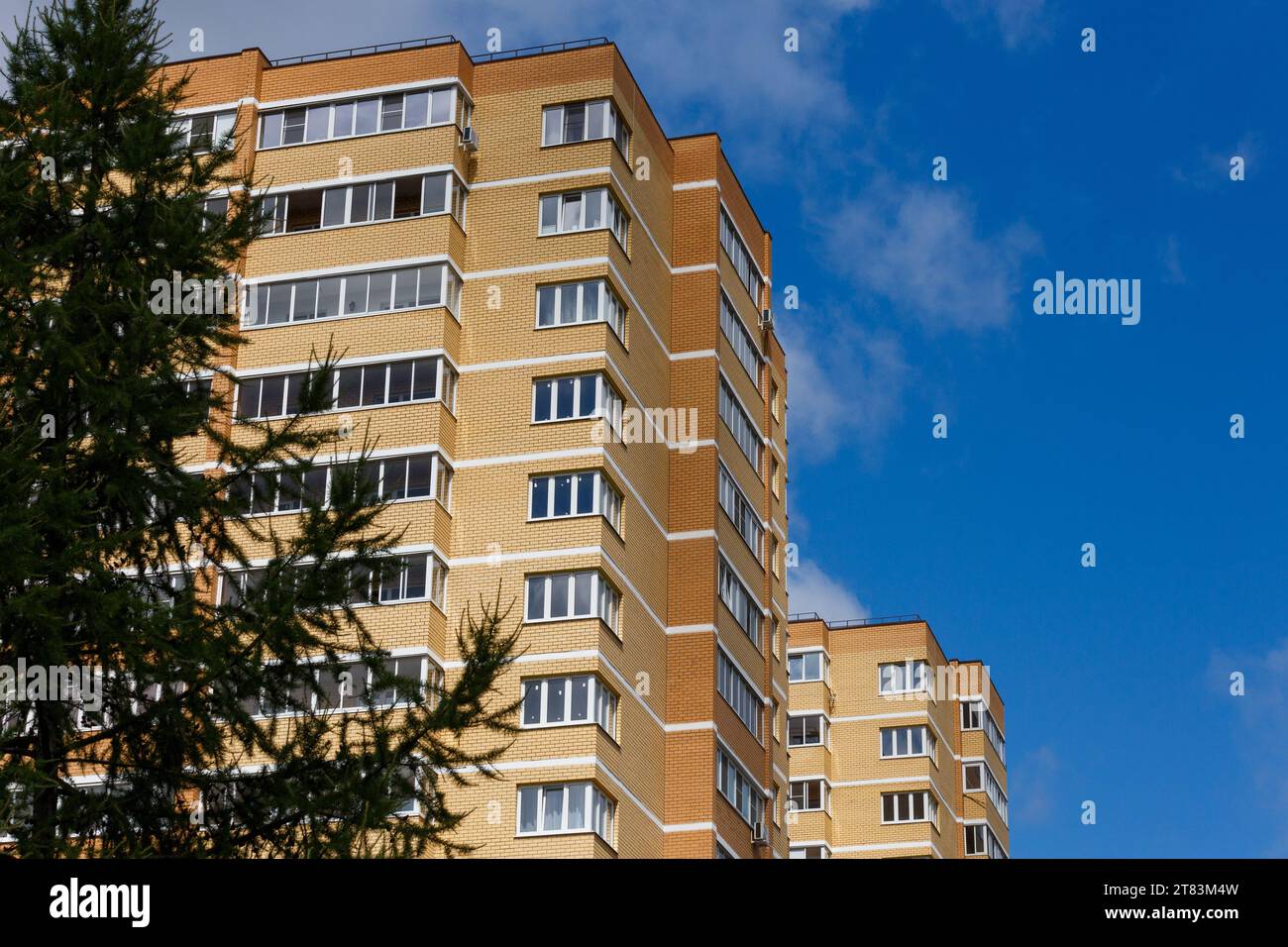 new high rise brick apartment buildings with spruce tree Stock Photo ...