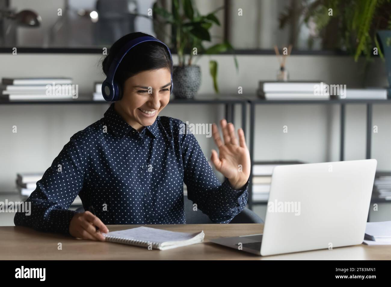 Happy Indian student wearing headphones, making video call to teacher ...