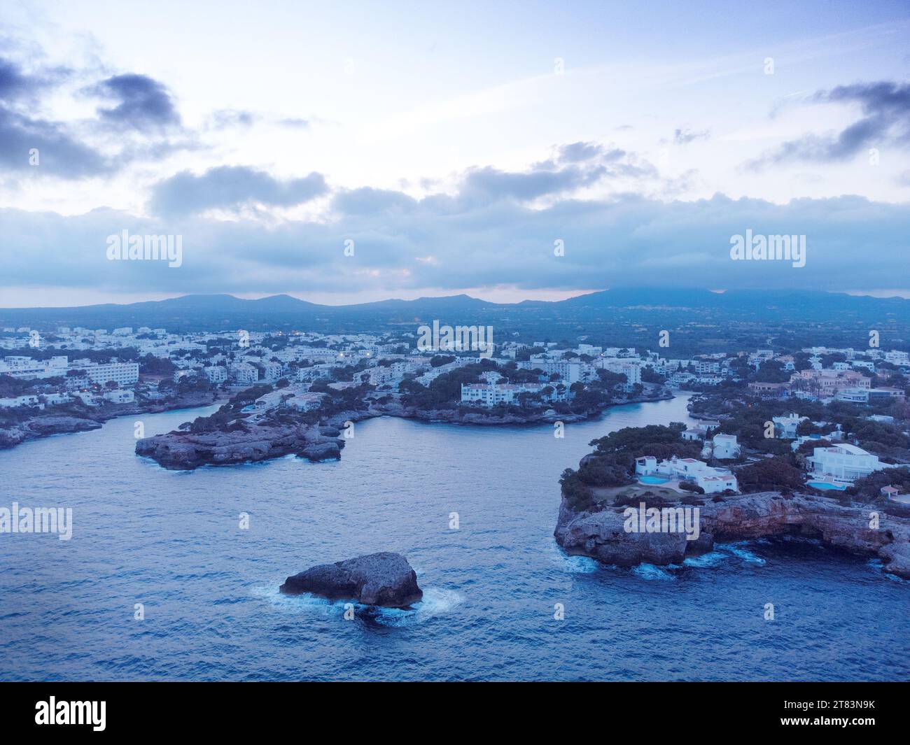 Aerial view of Cala Esmeralda at night , above the sea looking back at ...