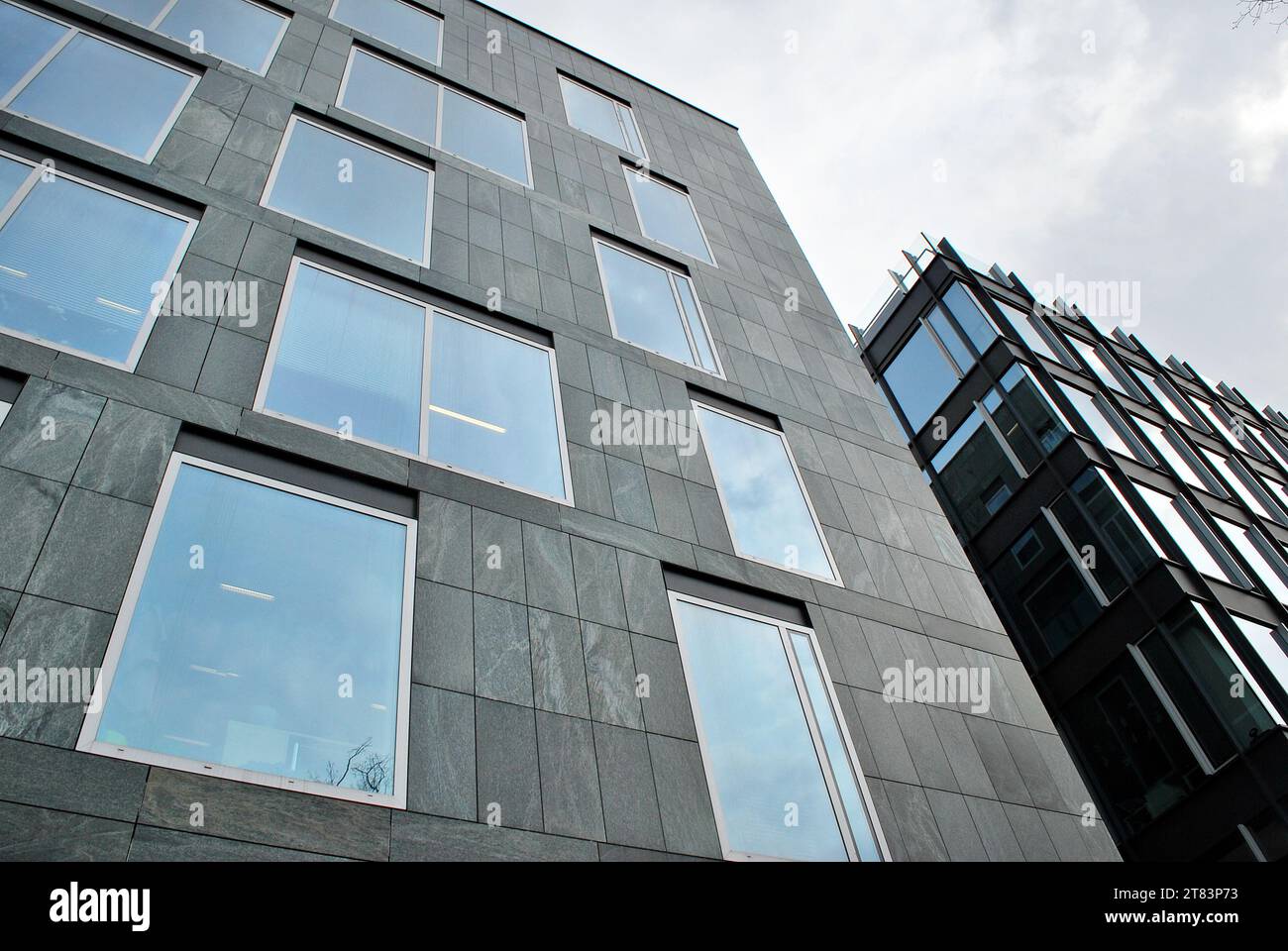 Abstract closeup of the glass-clad facade of a modern building covered ...
