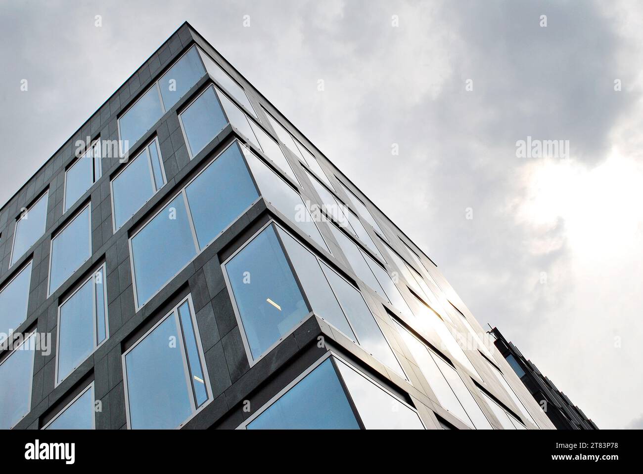 Abstract closeup of the glass-clad facade of a modern building covered ...