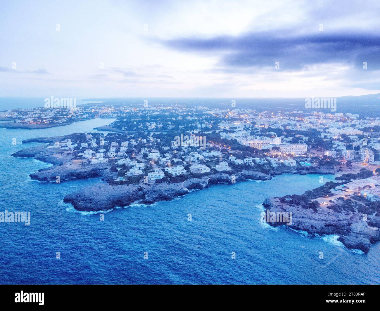 Aerial view of Cala Esmeralda at night , above the sea looking back at ...