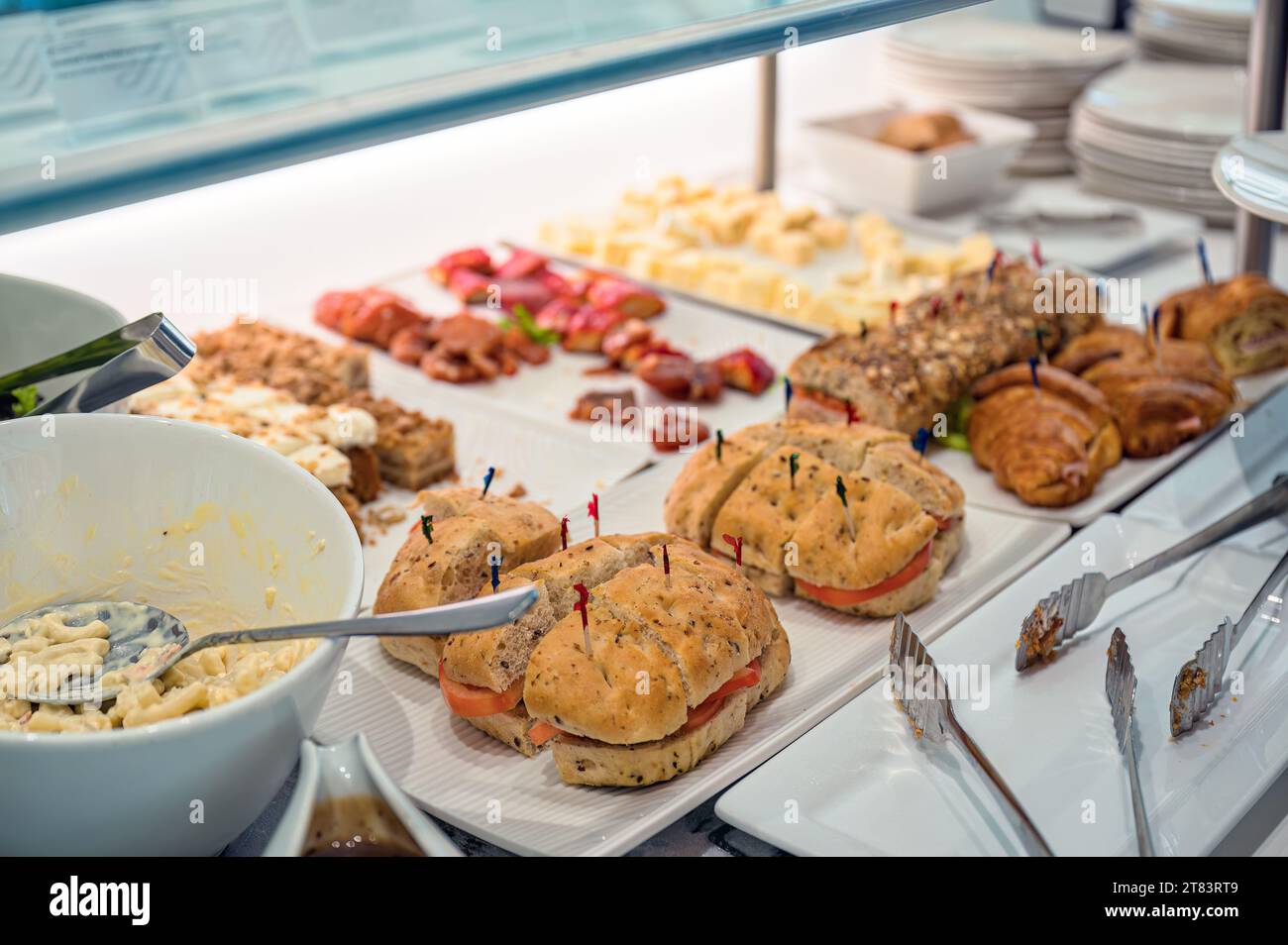 Assorted selection buffet of bread, dessert and salad on pastry counter ...