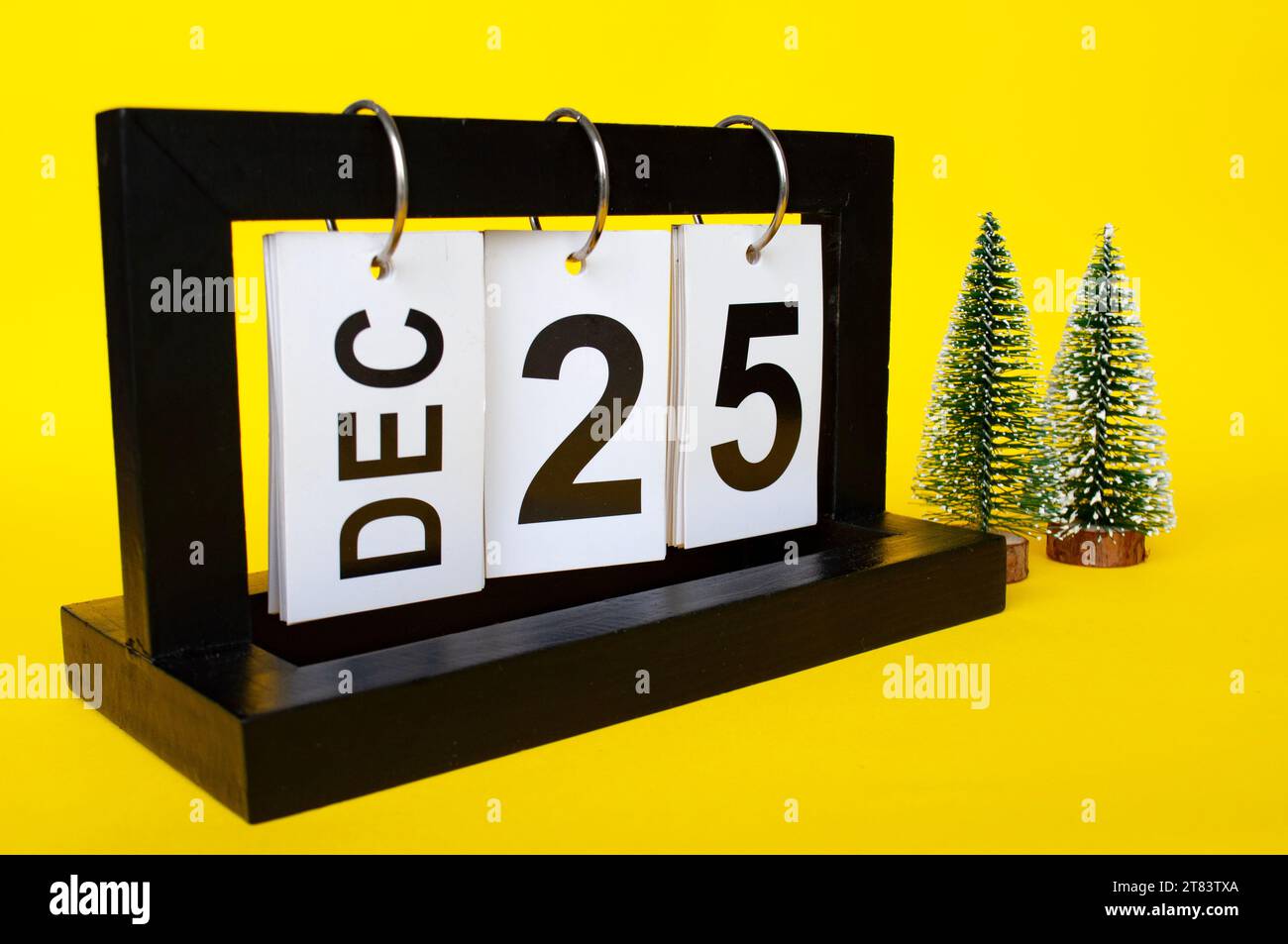 25 December calendar with Christmas trees on yellow background ...