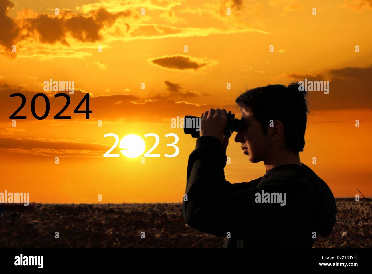 Concept of a businessman looking at the year 2024 through binoculars ...
