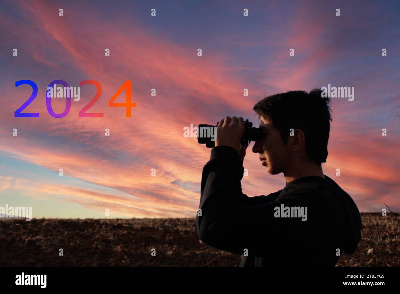 Concept of a businessman looking at the year 2024 through binoculars ...