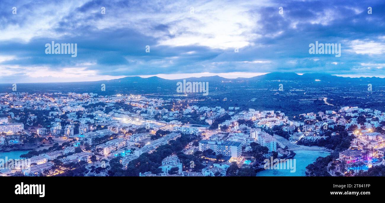 Aerial view of Cala Esmeralda at night , above the sea looking back at ...