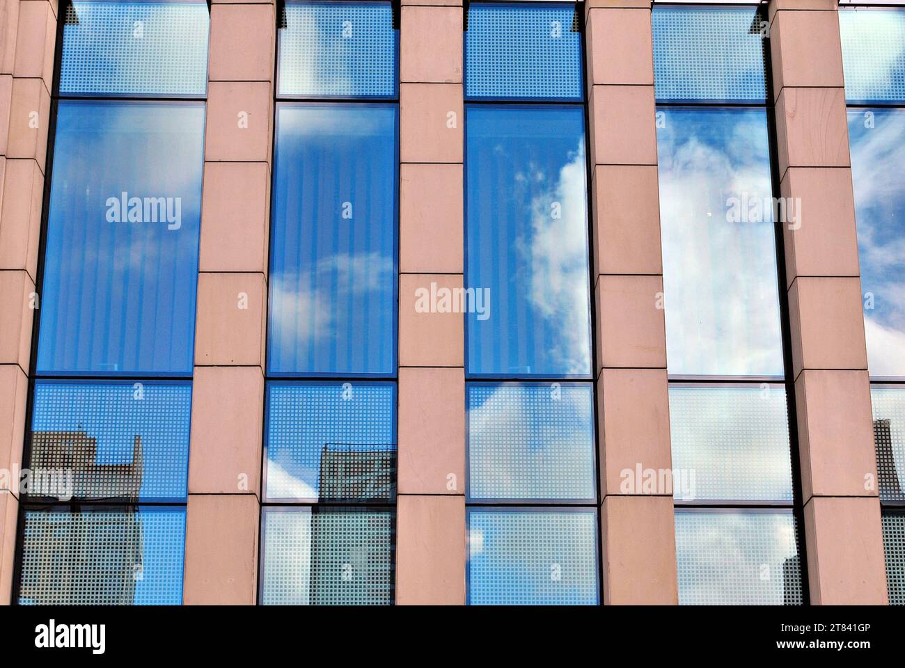 Abstract closeup of the glass-clad facade of a modern building covered ...