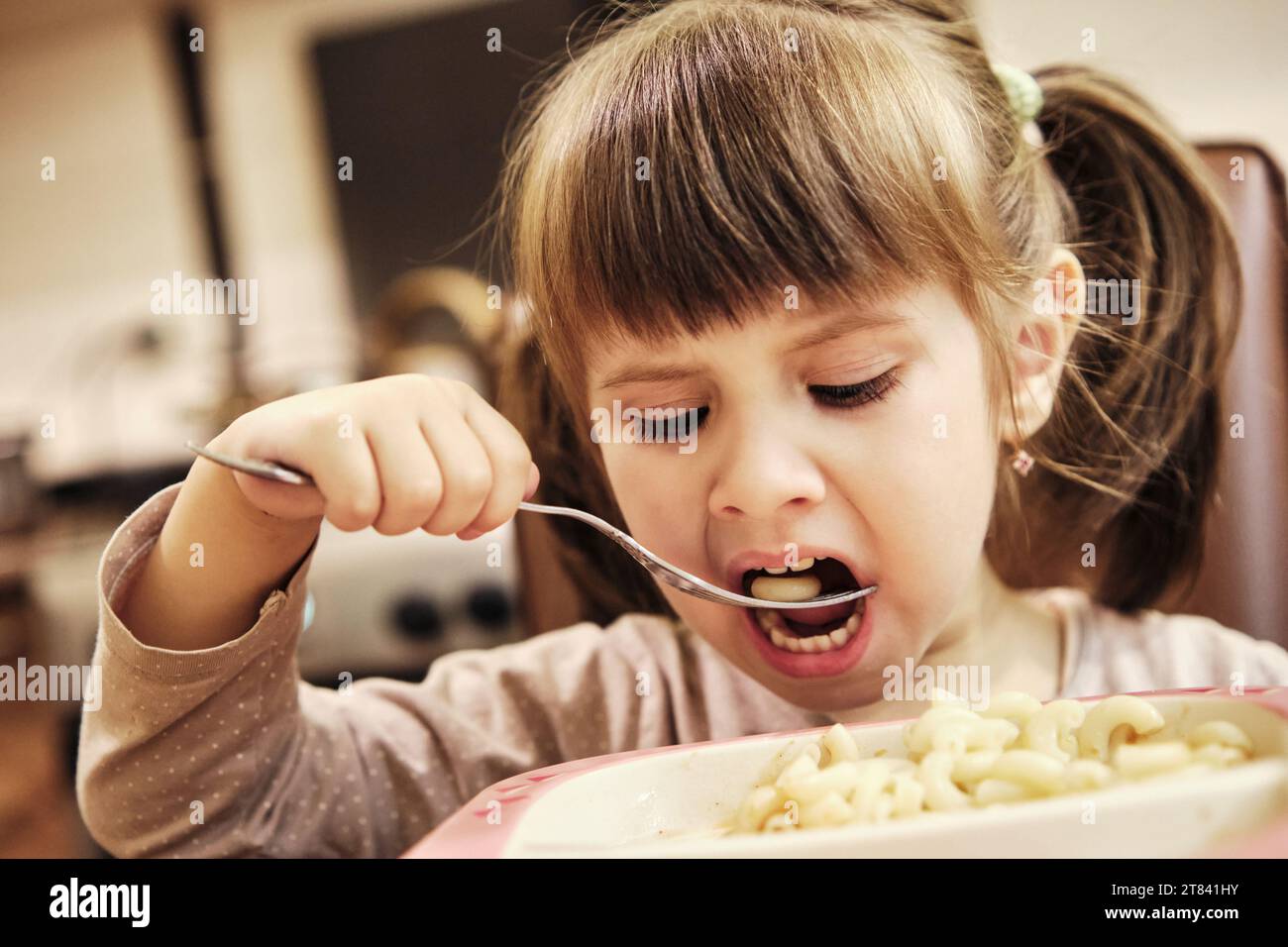 Child eating shaped pasta Stock Photo - Alamy