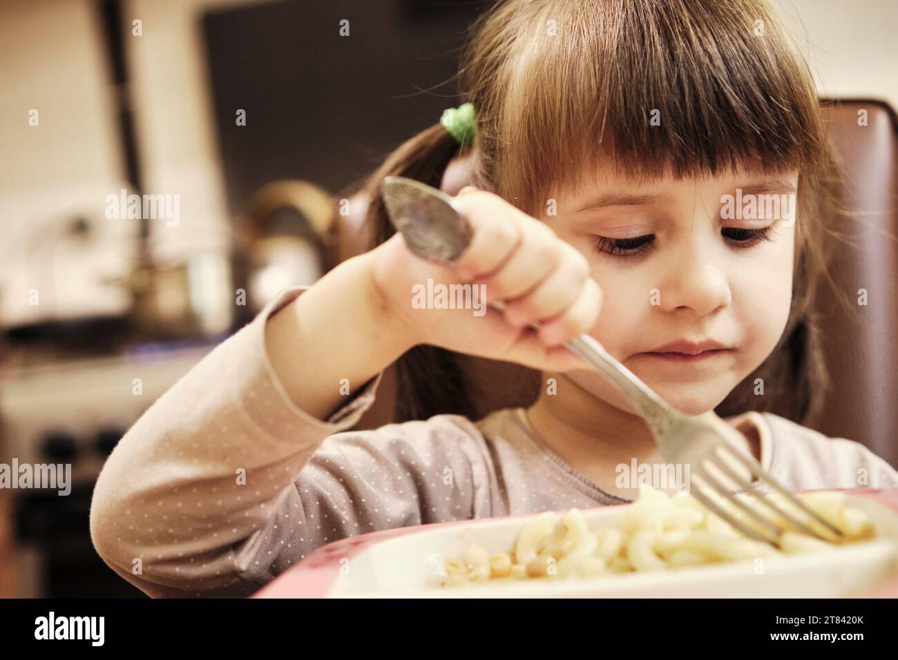 Child eating shaped pasta Stock Photo - Alamy